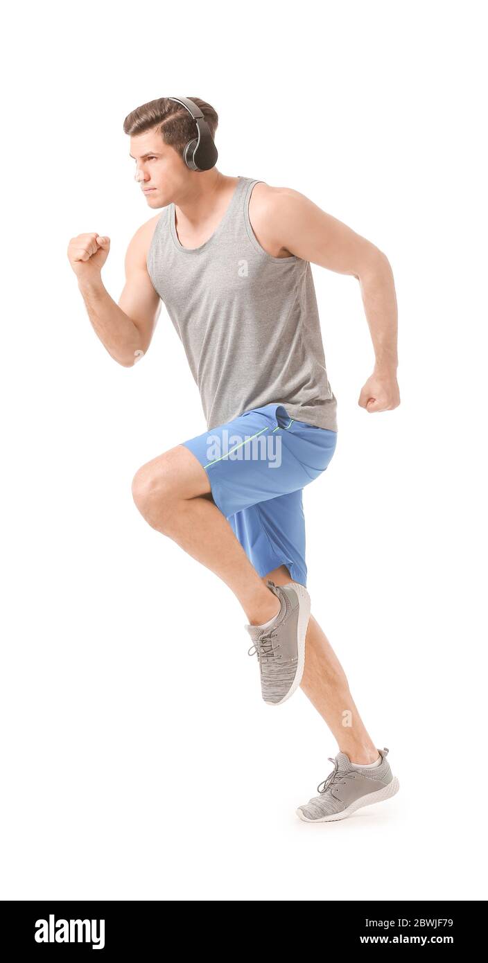 Sporty running young man on white background Stock Photo - Alamy