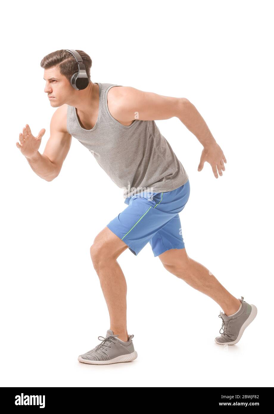 Sporty running young man on white background Stock Photo - Alamy