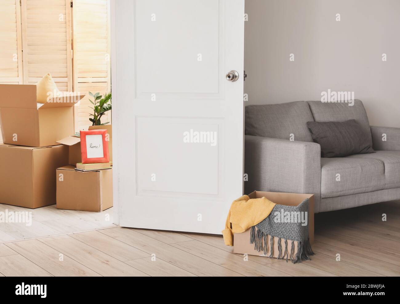 Cardboard boxes with belongings in new flat on moving day Stock Photo ...