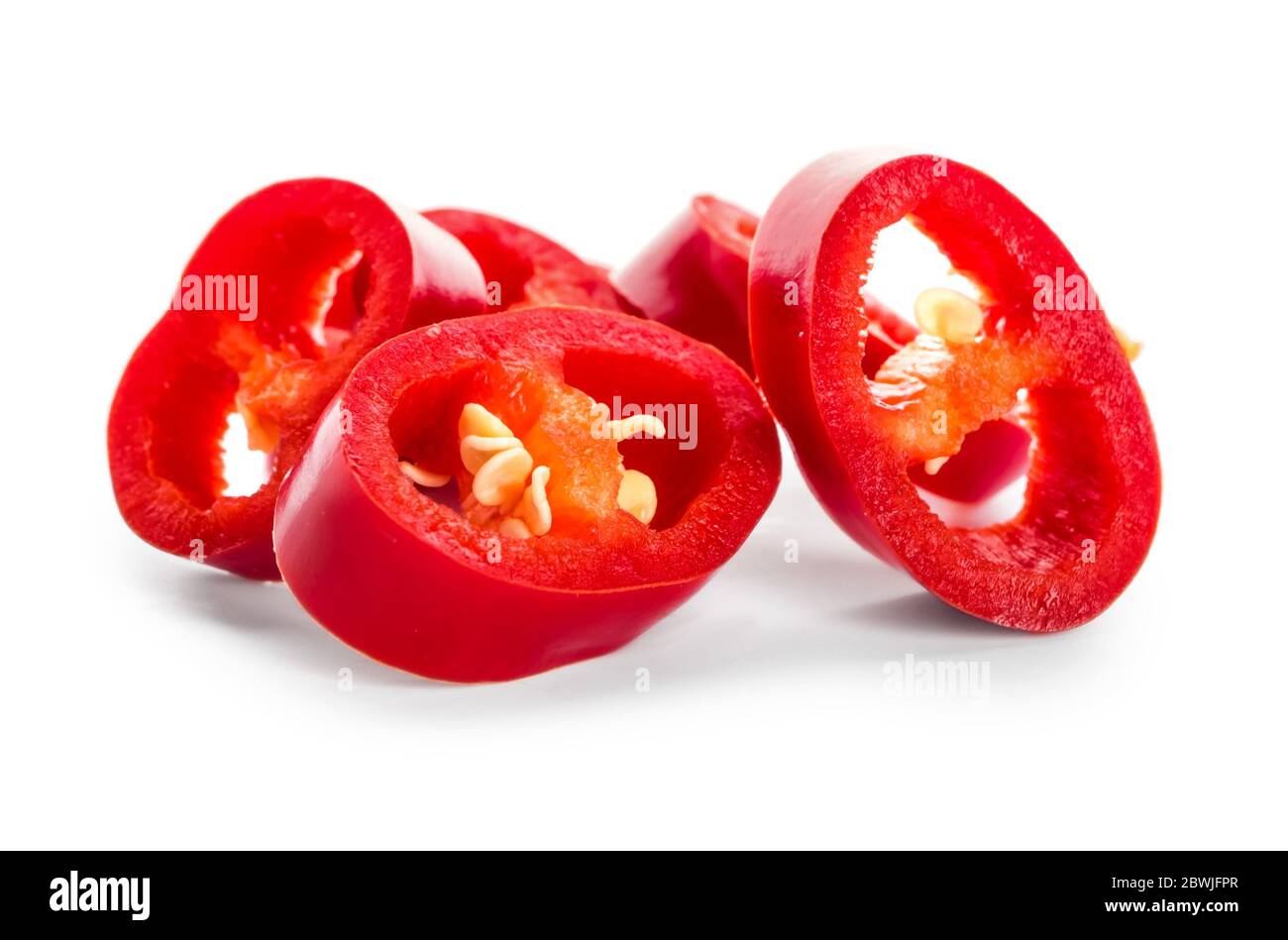 Cut chili pepper on white background Stock Photo - Alamy