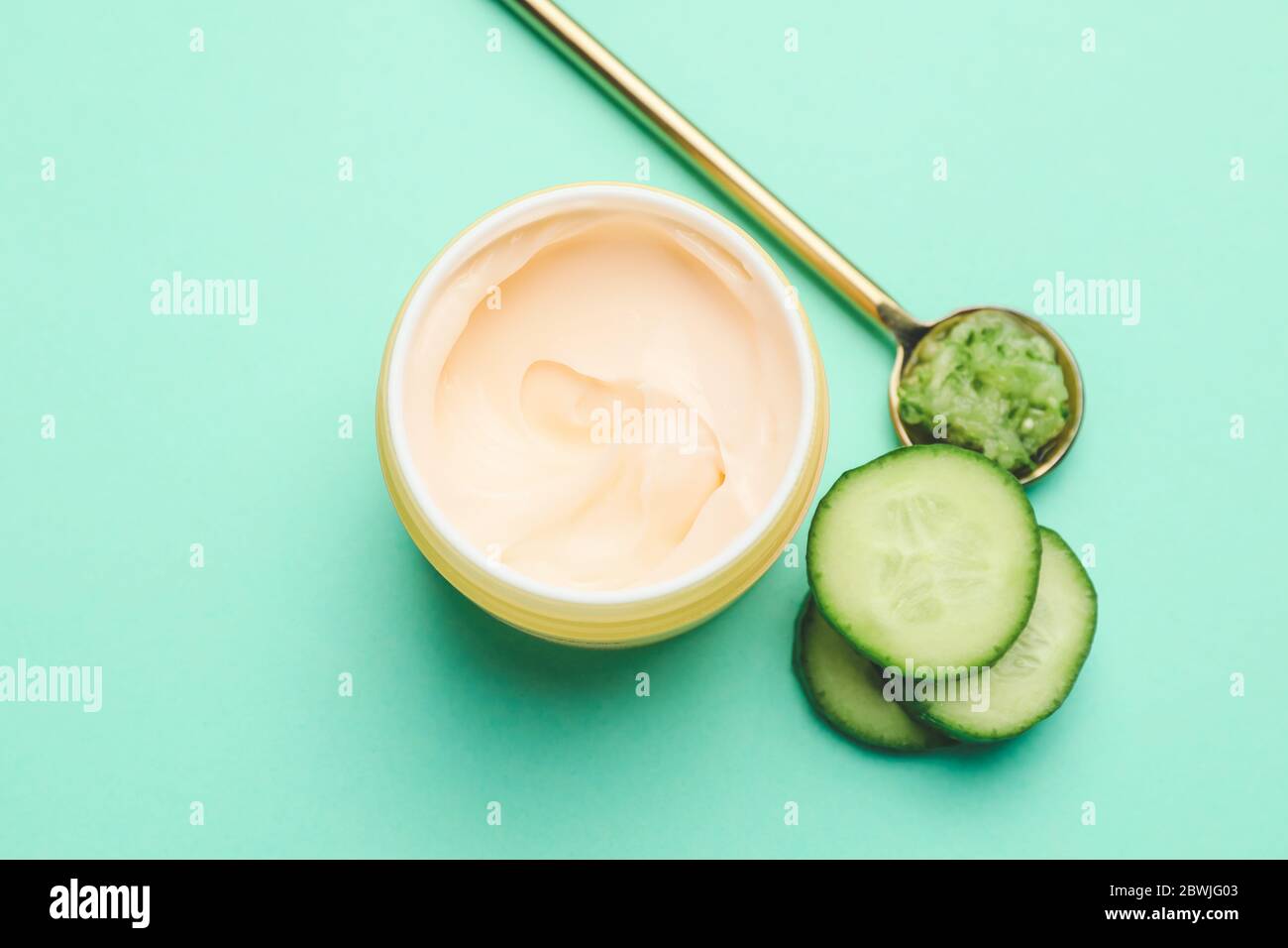 Cream with cucumber extract on color background Stock Photo - Alamy