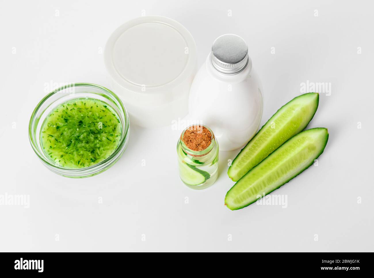 Cosmetics with cucumber extract on white background Stock Photo - Alamy