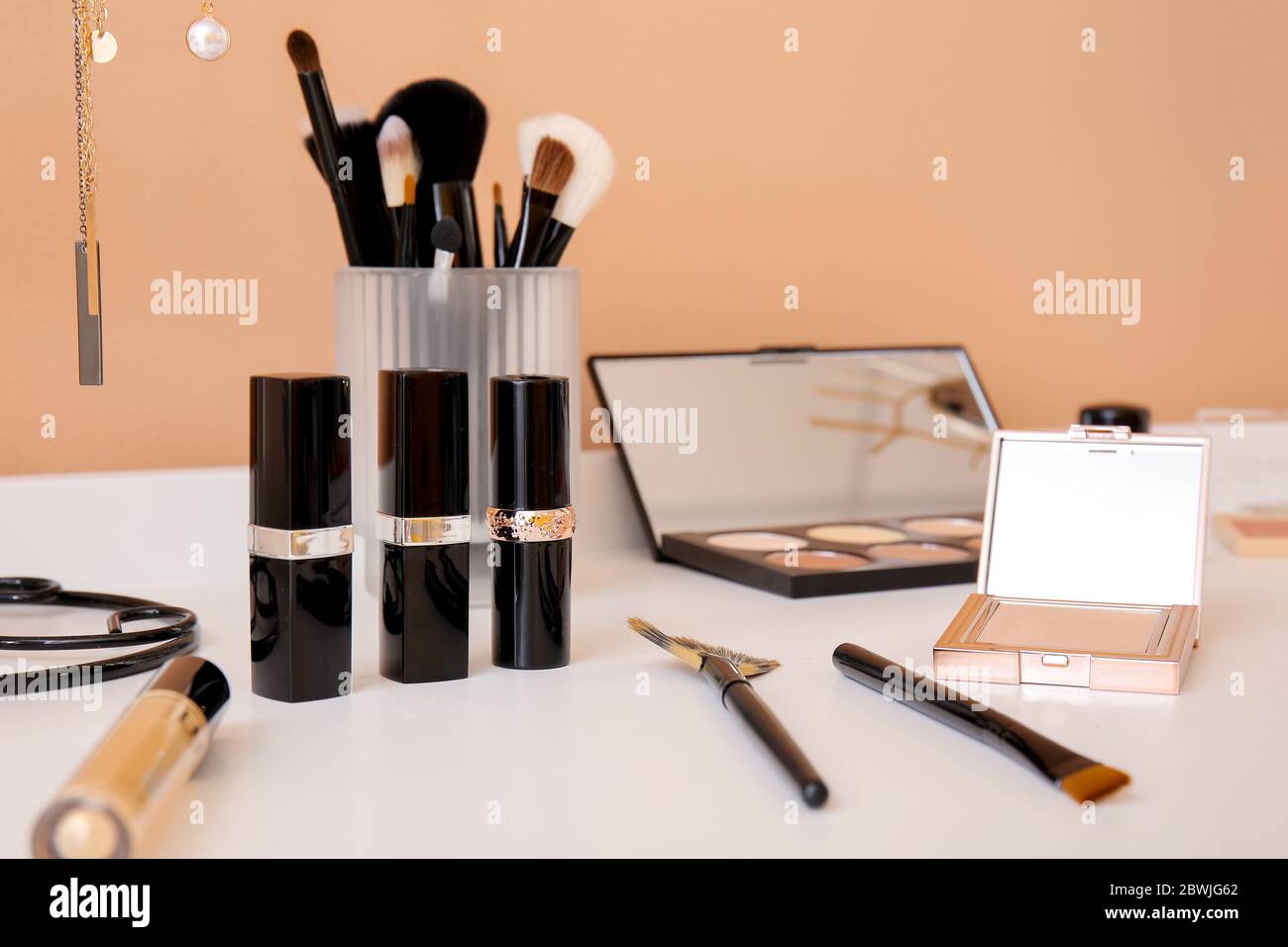 Table with makeup cosmetics in dressing room Stock Photo - Alamy