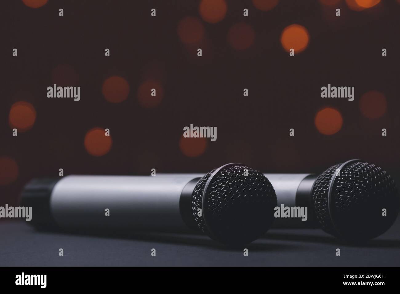 Modern microphones on dark background with blurred lights Stock Photo ...