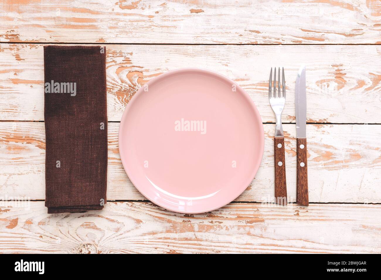 Simple table setting on wooden background Stock Photo - Alamy