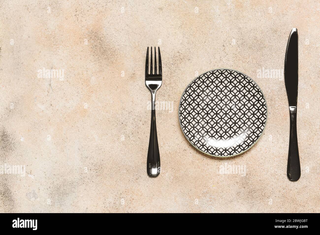 Simple table setting on light background Stock Photo - Alamy