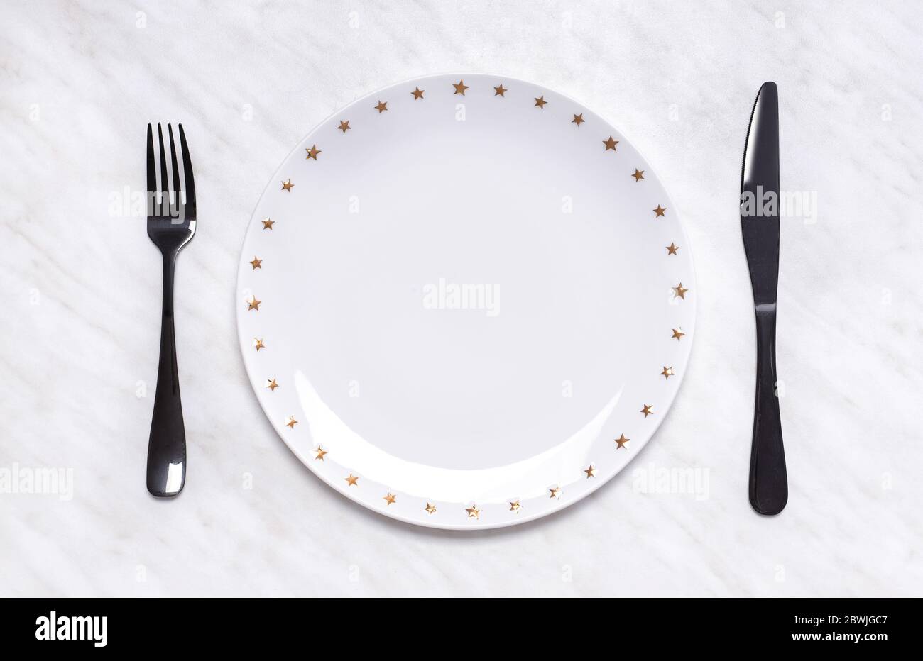 Simple table setting on light background Stock Photo - Alamy