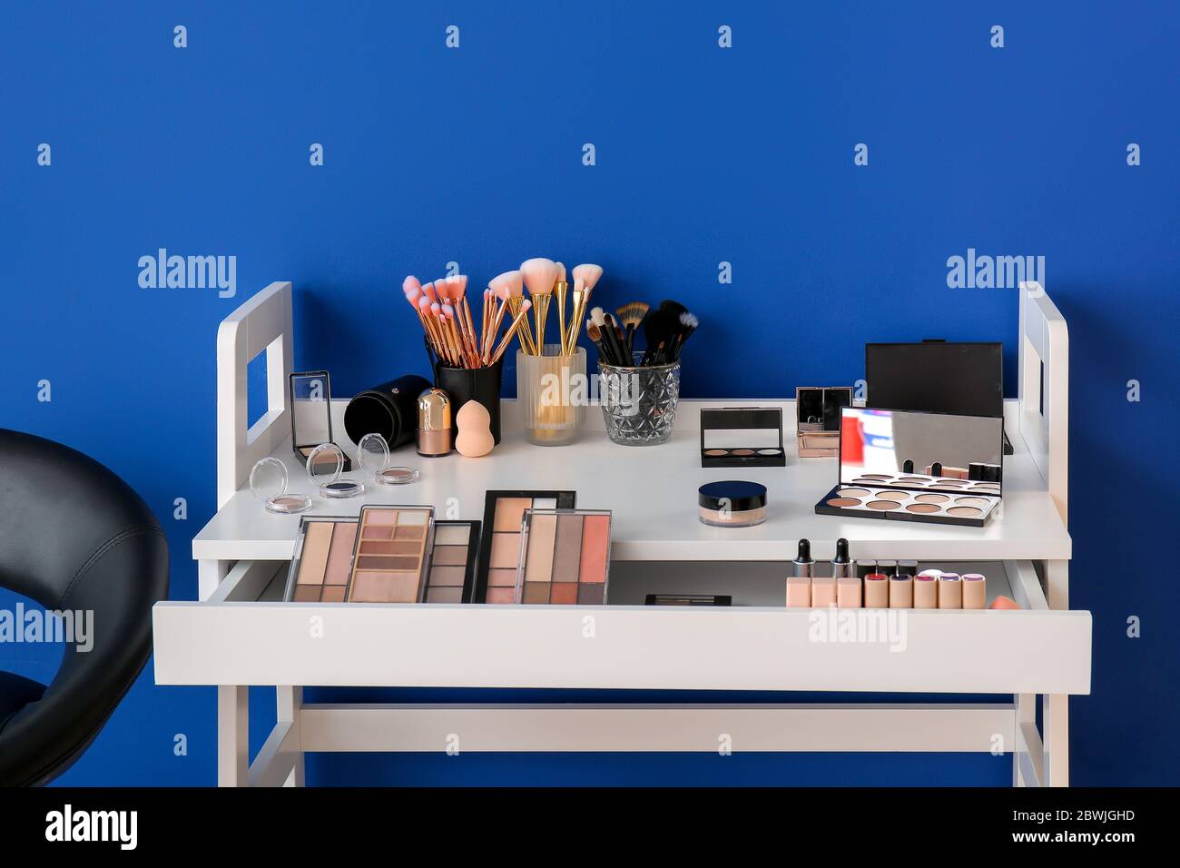 Table with makeup cosmetics in modern dressing room Stock Photo - Alamy