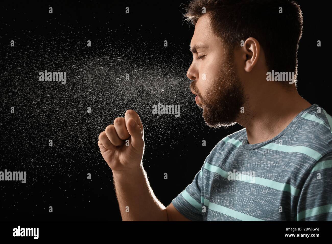 Coughing man on dark background. Concept of epidemic Stock Photo - Alamy