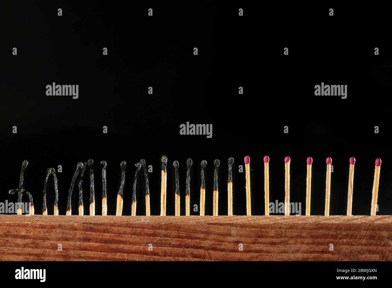 Burnt out and unburnt matches on dark background. Concept of social ...
