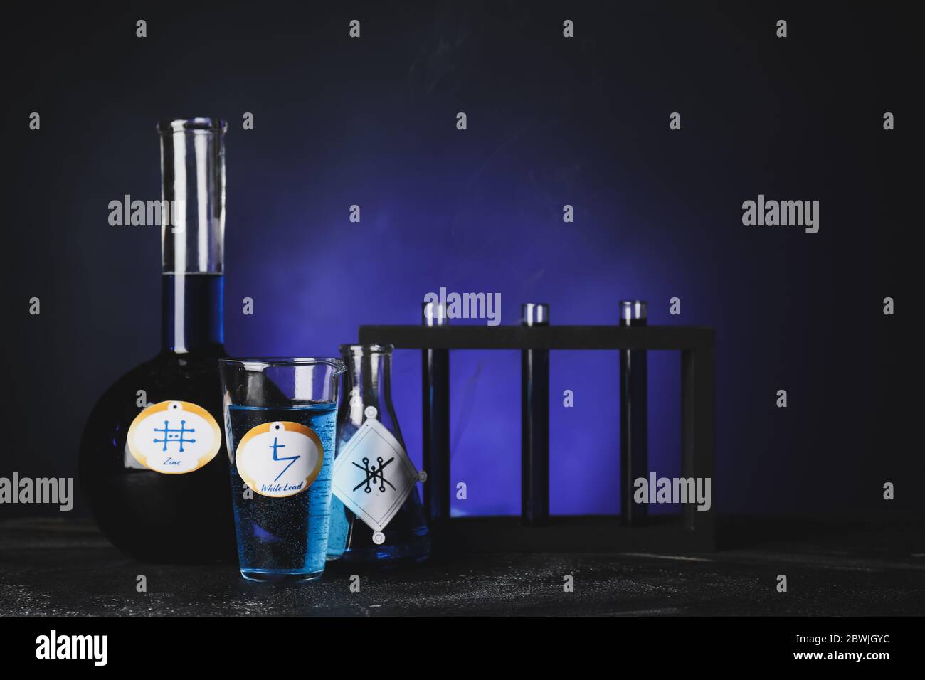 Potions with alchemical symbols on table Stock Photo - Alamy