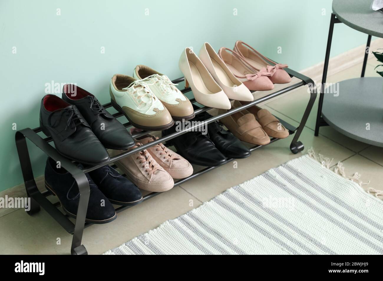 Stand with stylish shoes in interior of modern hall Stock Photo - Alamy