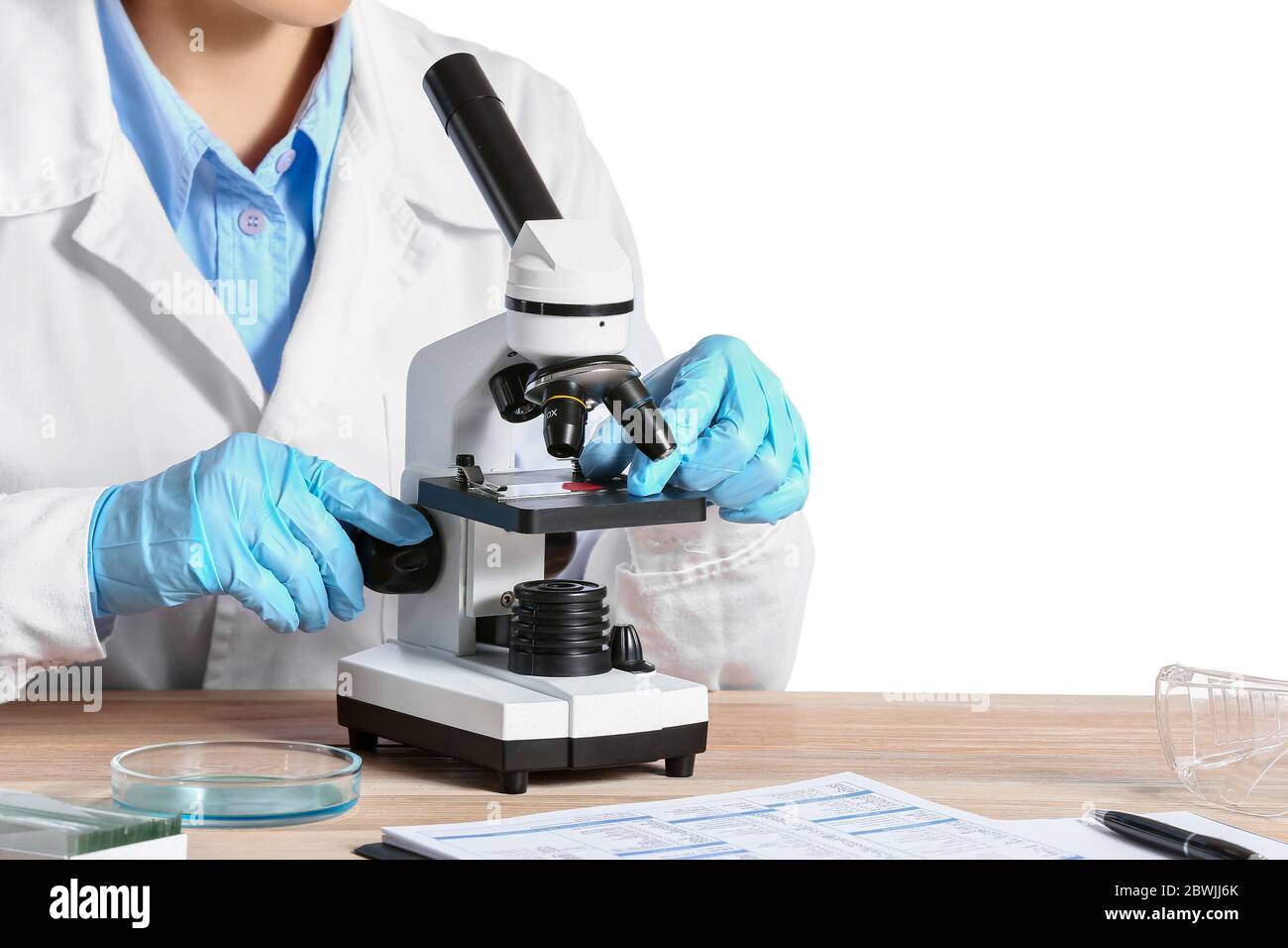 Scientist working with microscope against white background Stock Photo ...