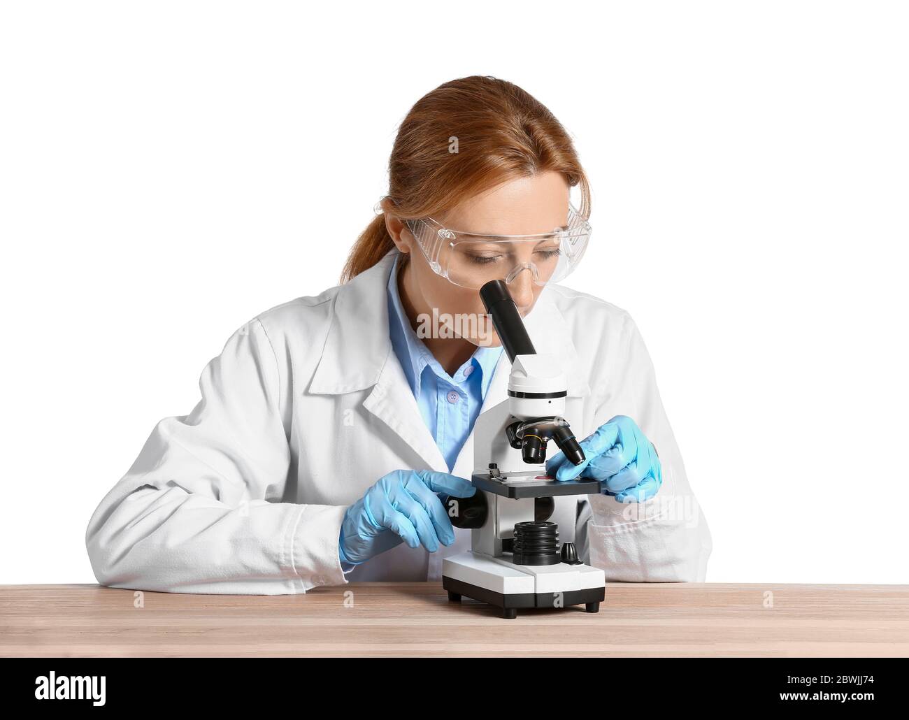 Scientist working with microscope against white background Stock Photo ...