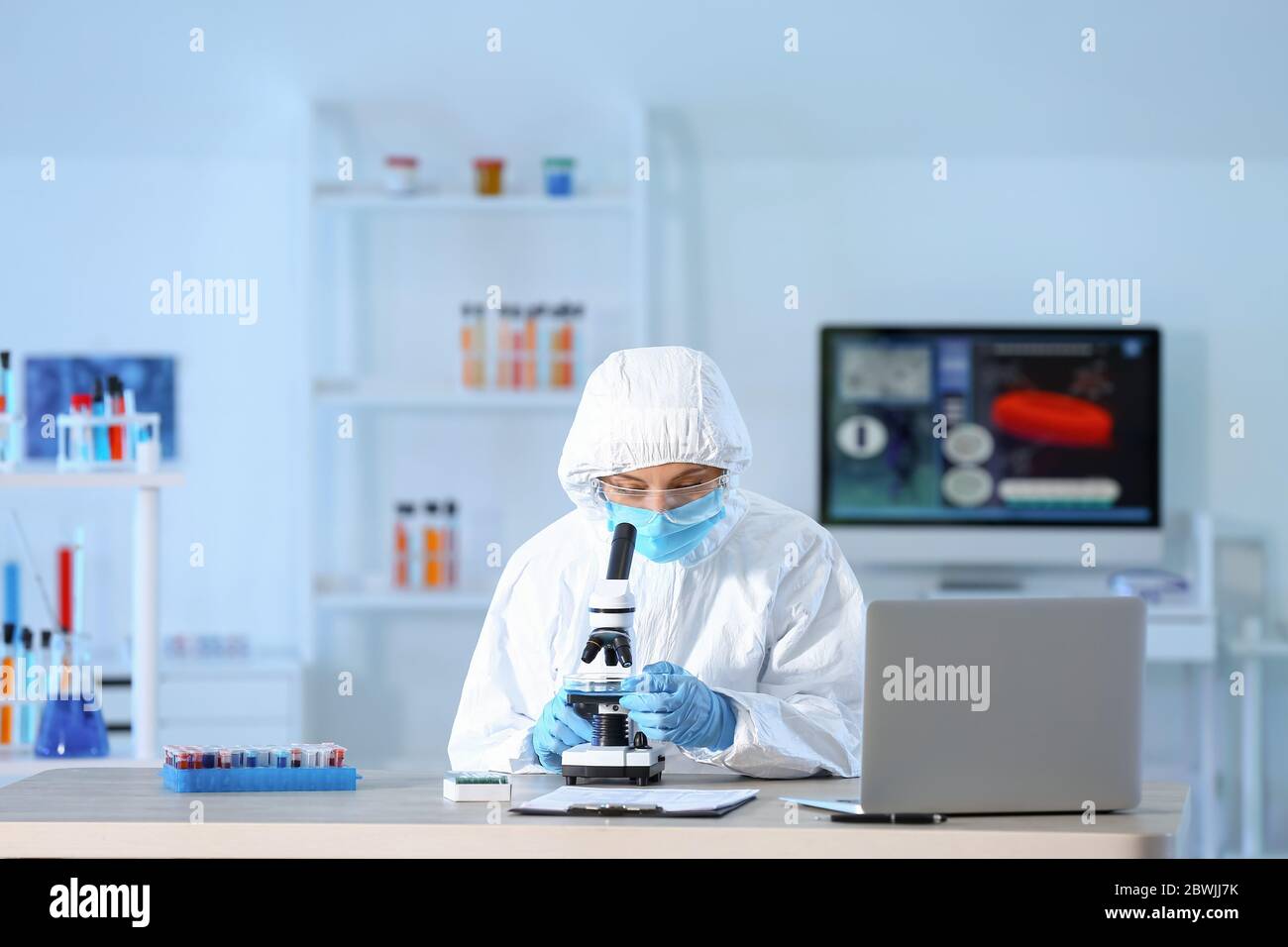 Scientist working with microscope in laboratory Stock Photo - Alamy