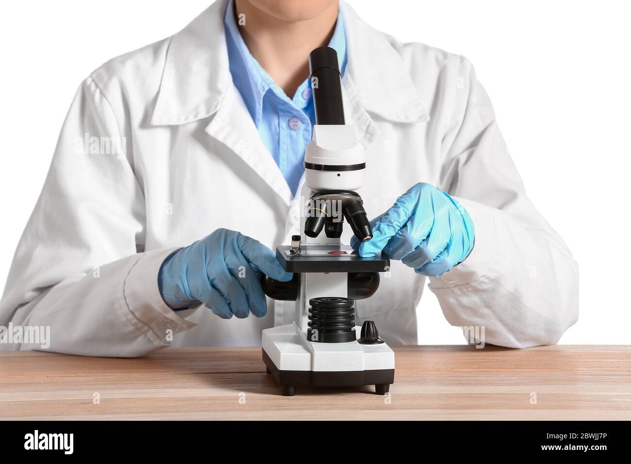 Scientist working with microscope against white background Stock Photo ...