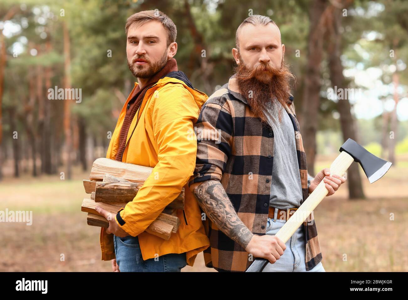 Two handsome lumberjacks in forest Stock Photo - Alamy