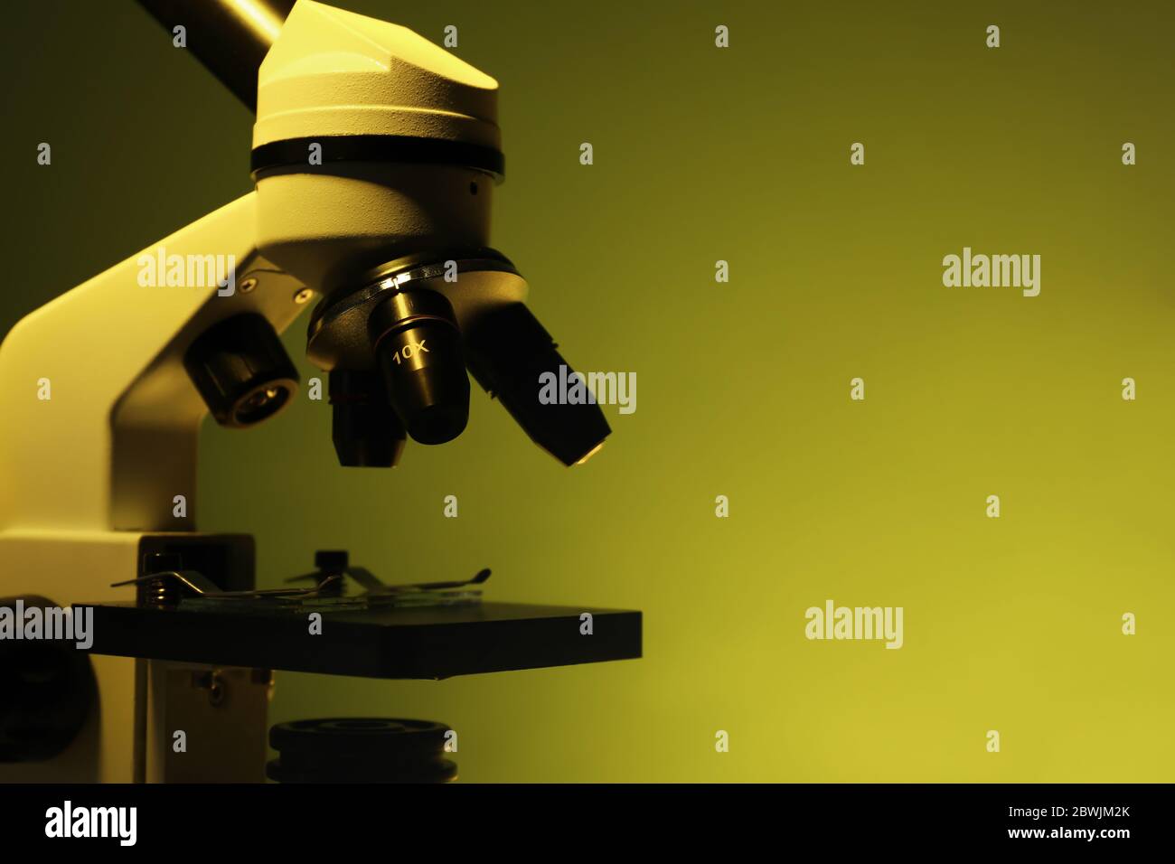 Modern microscope on color background Stock Photo - Alamy