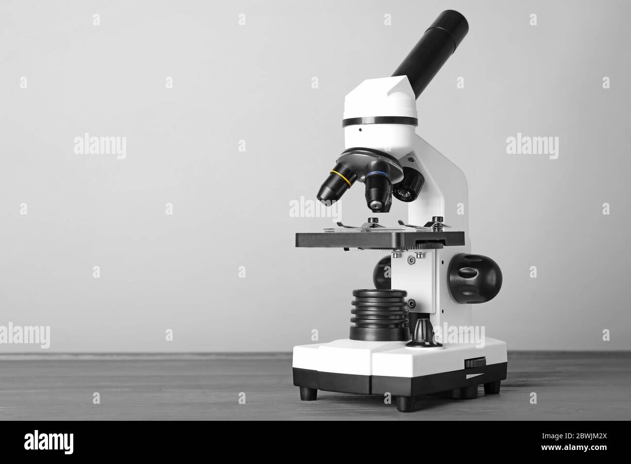 Modern microscope on table against grey background Stock Photo - Alamy