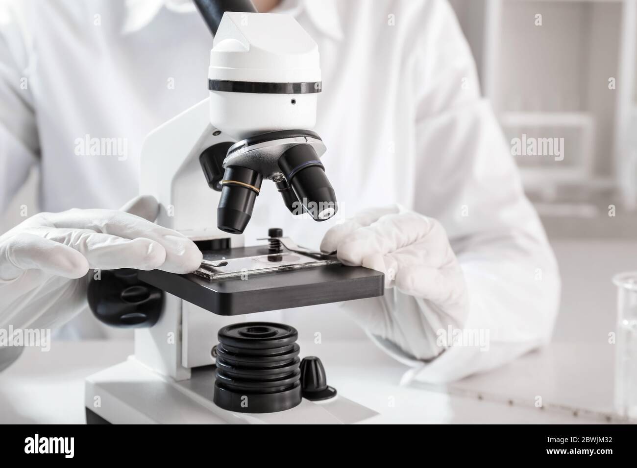 Scientist using microscope in laboratory Stock Photo - Alamy