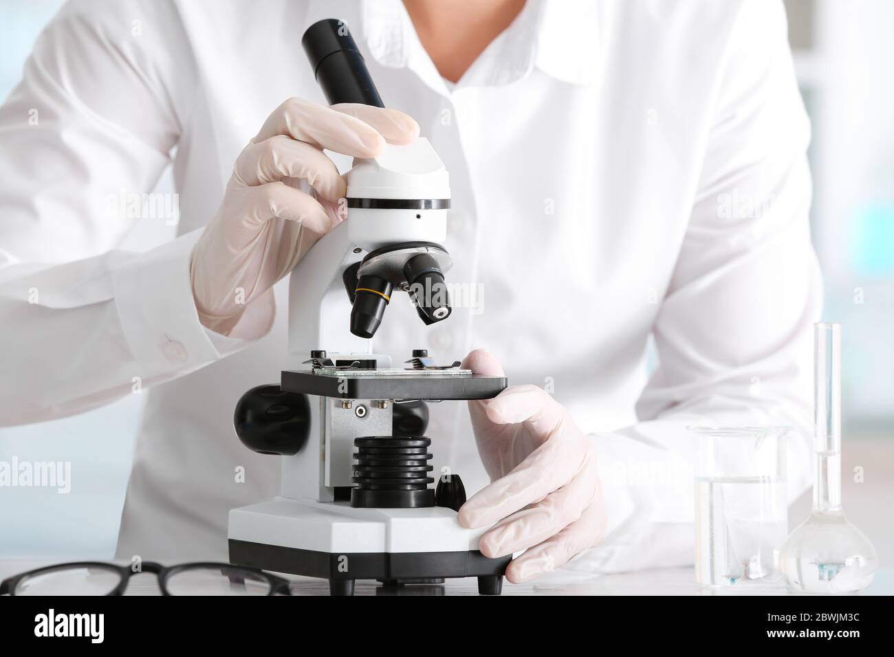 Scientist using microscope in laboratory Stock Photo - Alamy