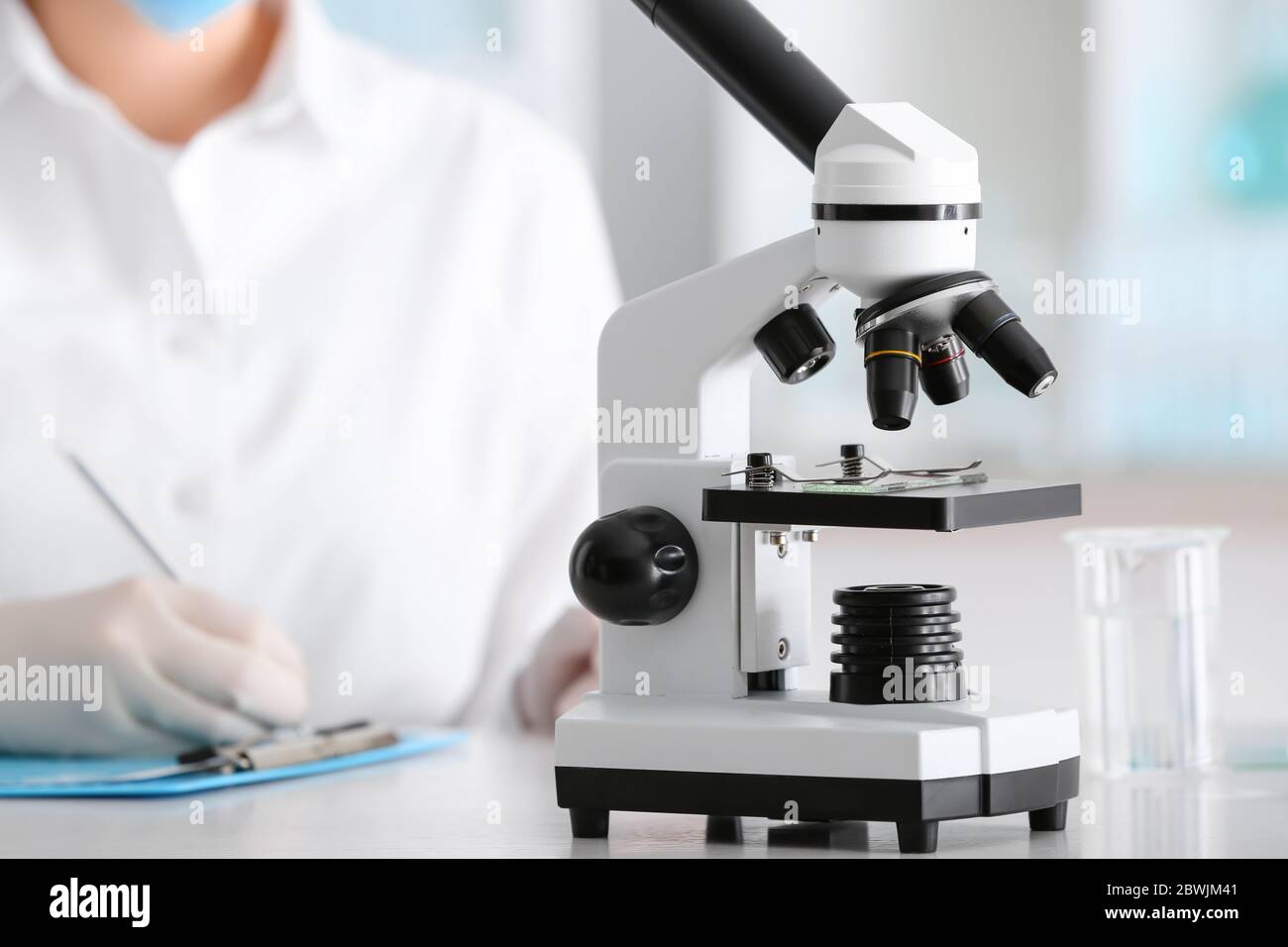Modern microscope on table in laboratory Stock Photo - Alamy