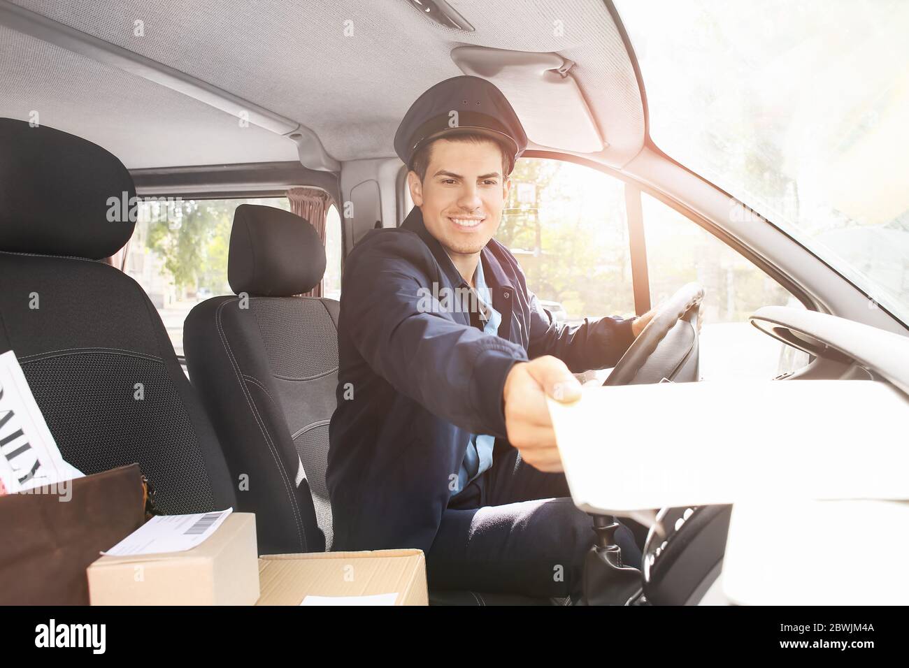 Young postman hi-res stock photography and images - Alamy