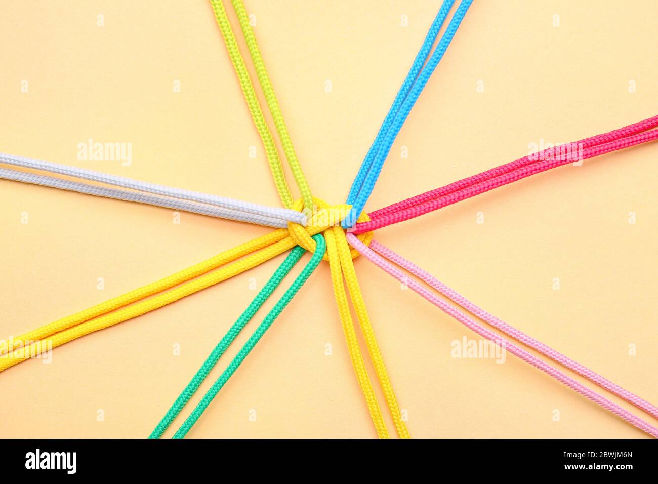 Tied ropes on color background. Unity concept Stock Photo - Alamy