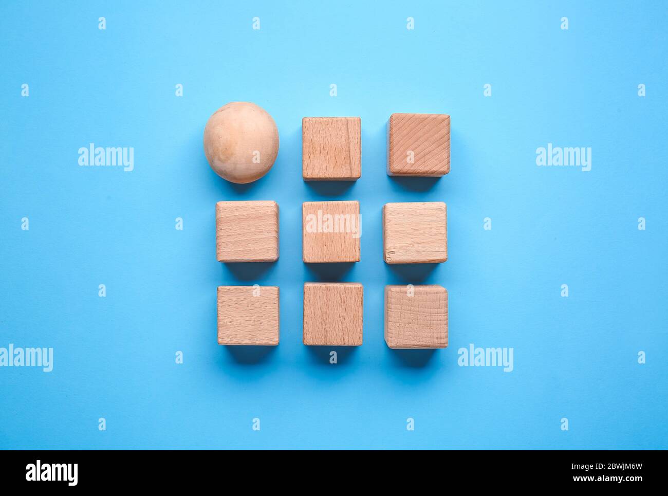 Wooden cubes and sphere on color background. Unity concept Stock Photo ...