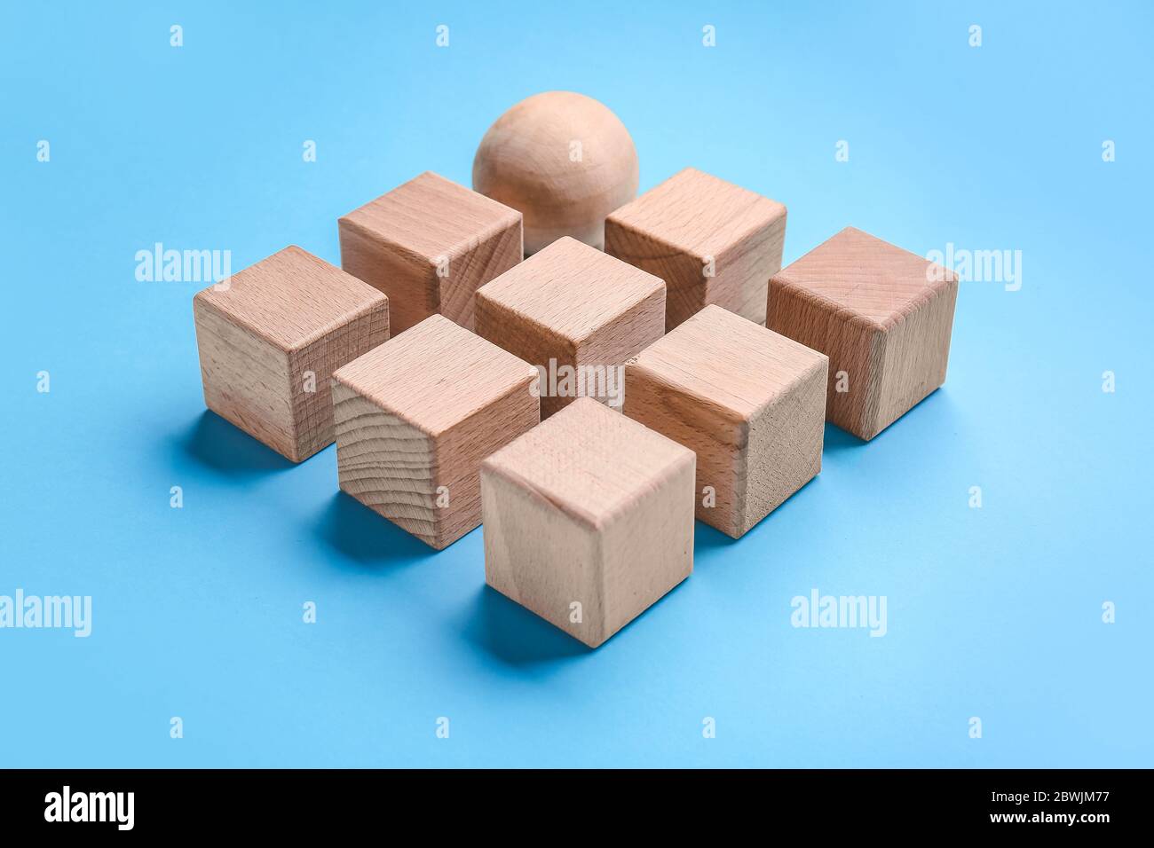 Wooden cubes and sphere on color background. Unity concept Stock Photo ...