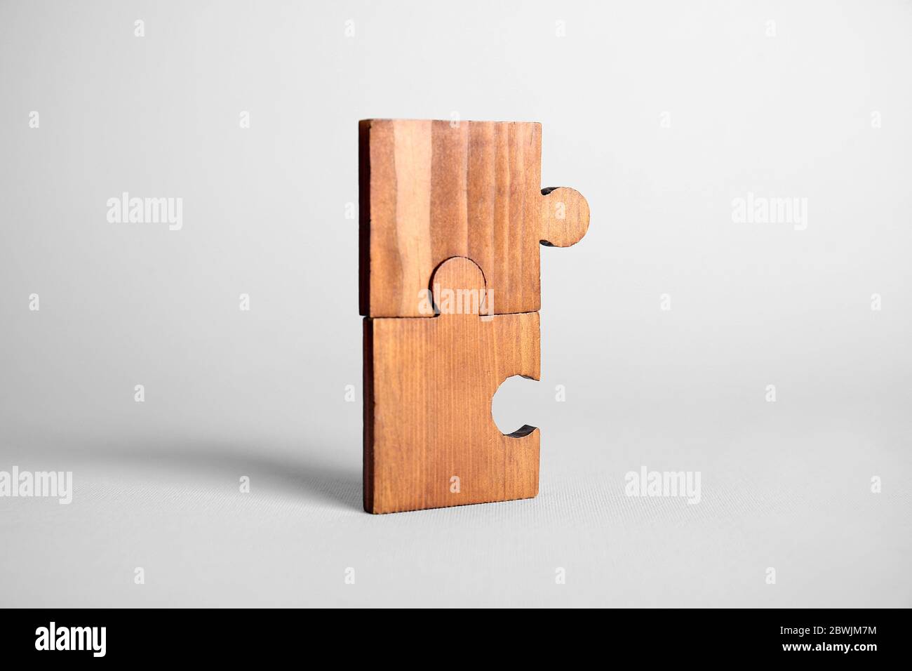 Pieces of jigsaw puzzle on light background. Unity concept Stock Photo ...