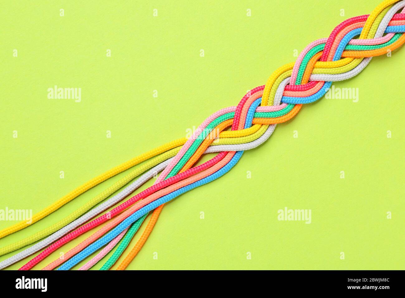 Braided ropes on color background. Unity concept Stock Photo - Alamy