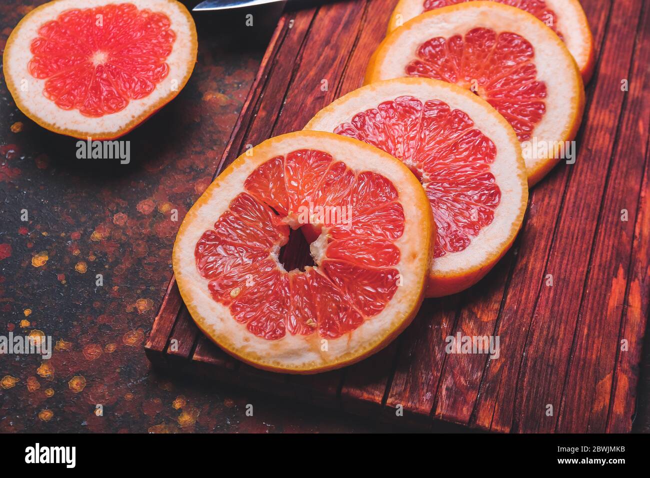 Fresh cut grapefruit on table Stock Photo - Alamy