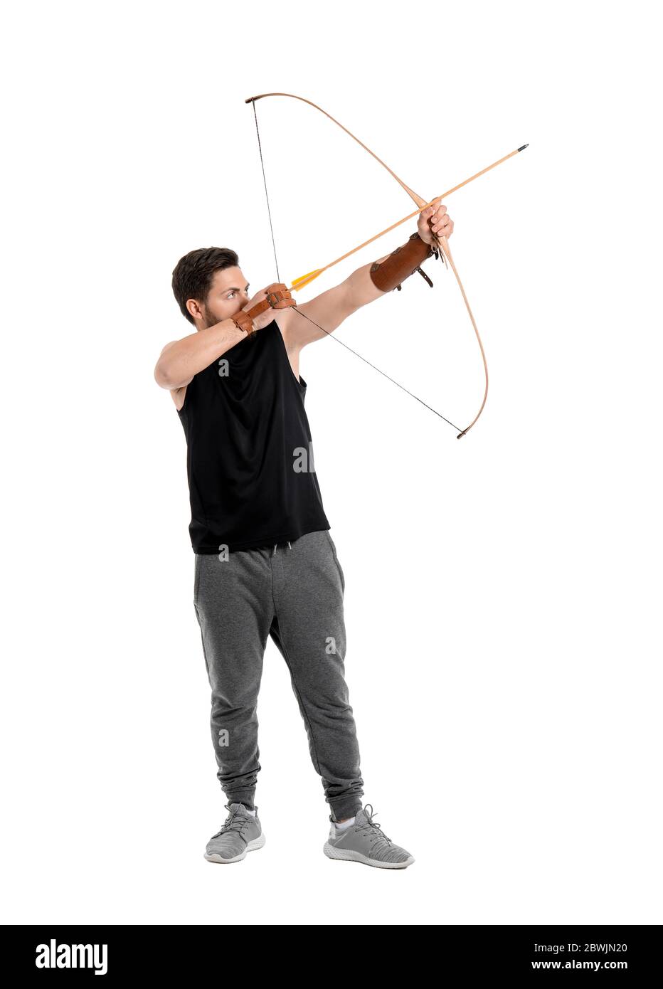 Handsome man with crossbow on white background Stock Photo - Alamy