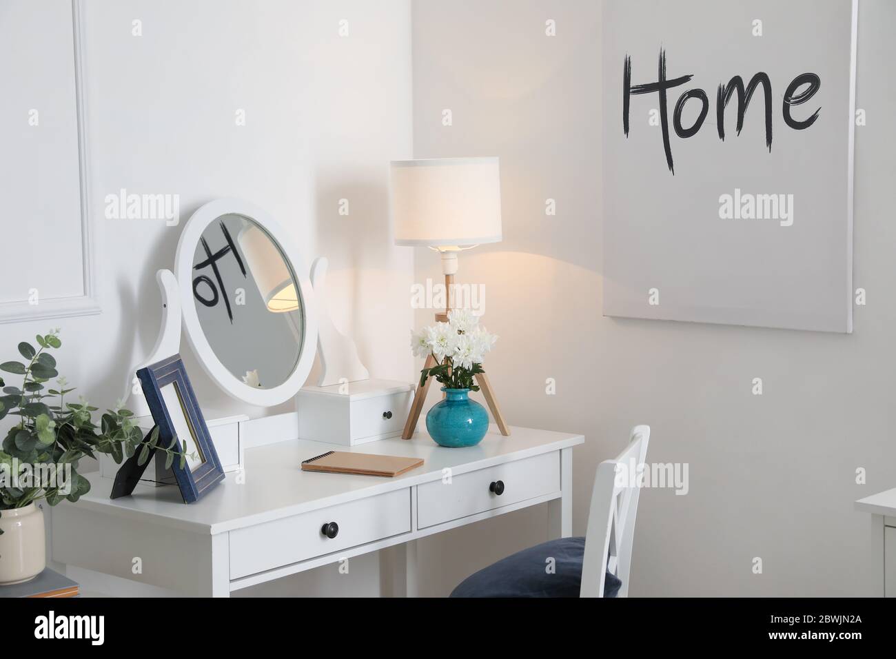 Stylish dressing table with glowing lamp at home Stock Photo - Alamy