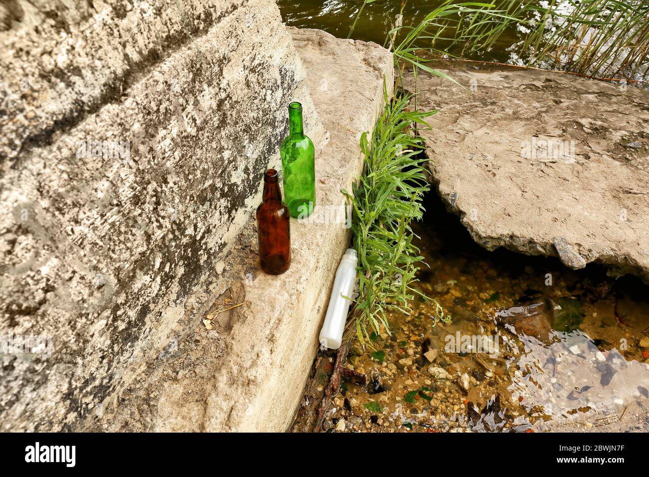 View of garbage near river outdoors. Concept of soil pollution Stock ...