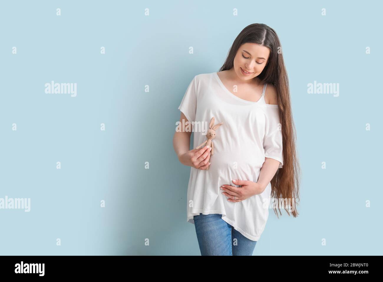 Beautiful pregnant woman on color background Stock Photo - Alamy