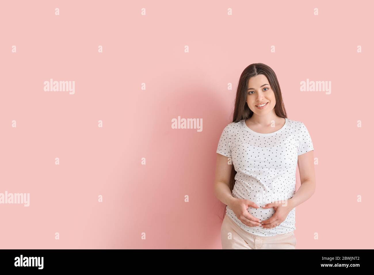 Beautiful pregnant woman on color background Stock Photo - Alamy