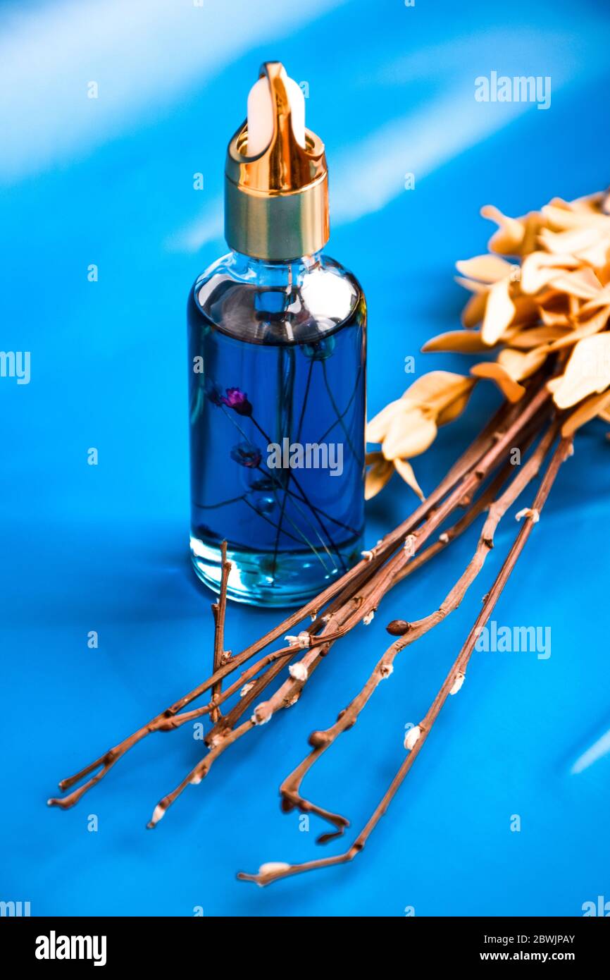 Anti aging serum in glass bottle with dropper on blue background and ...