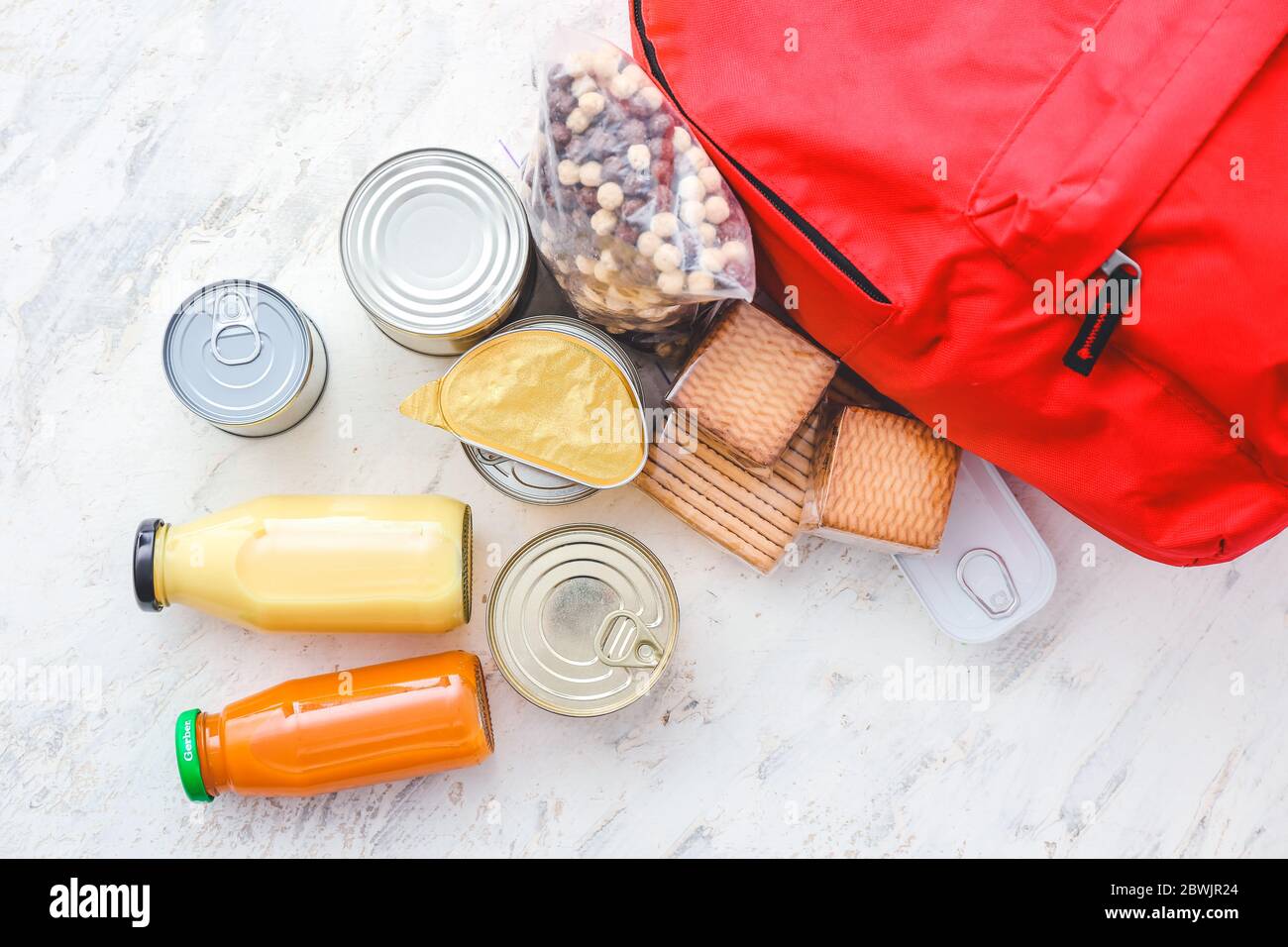 Schoolbag with different products on light background. Concept of ...