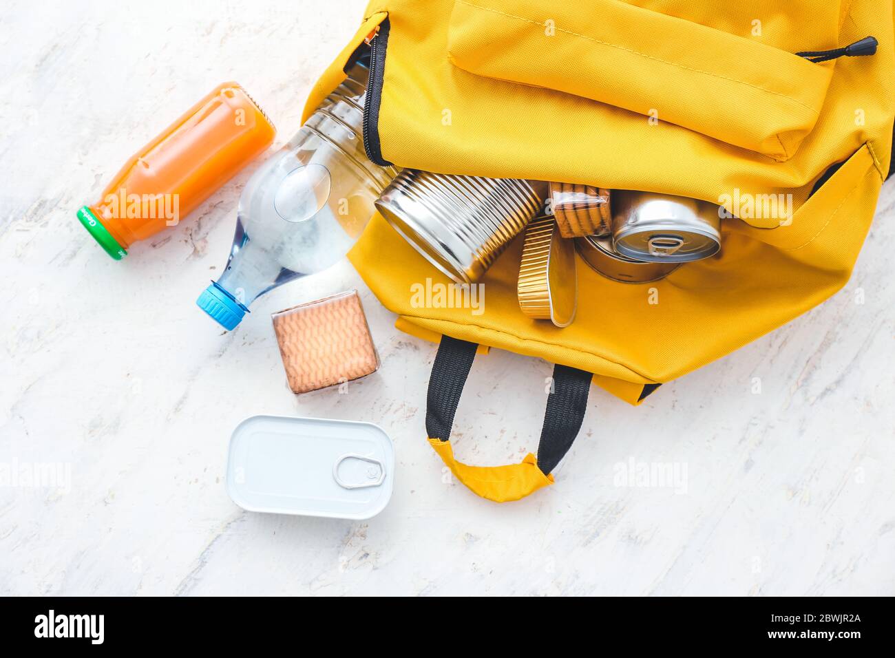 Schoolbag with different products on light background. Concept of ...