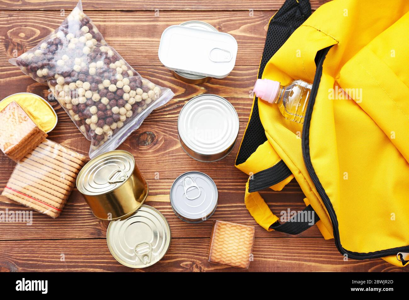 Schoolbag with different products on wooden background. Concept of ...