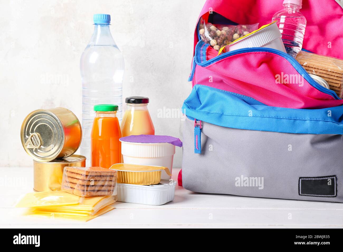 Schoolbag with different products on table. Concept of Backpack Food ...