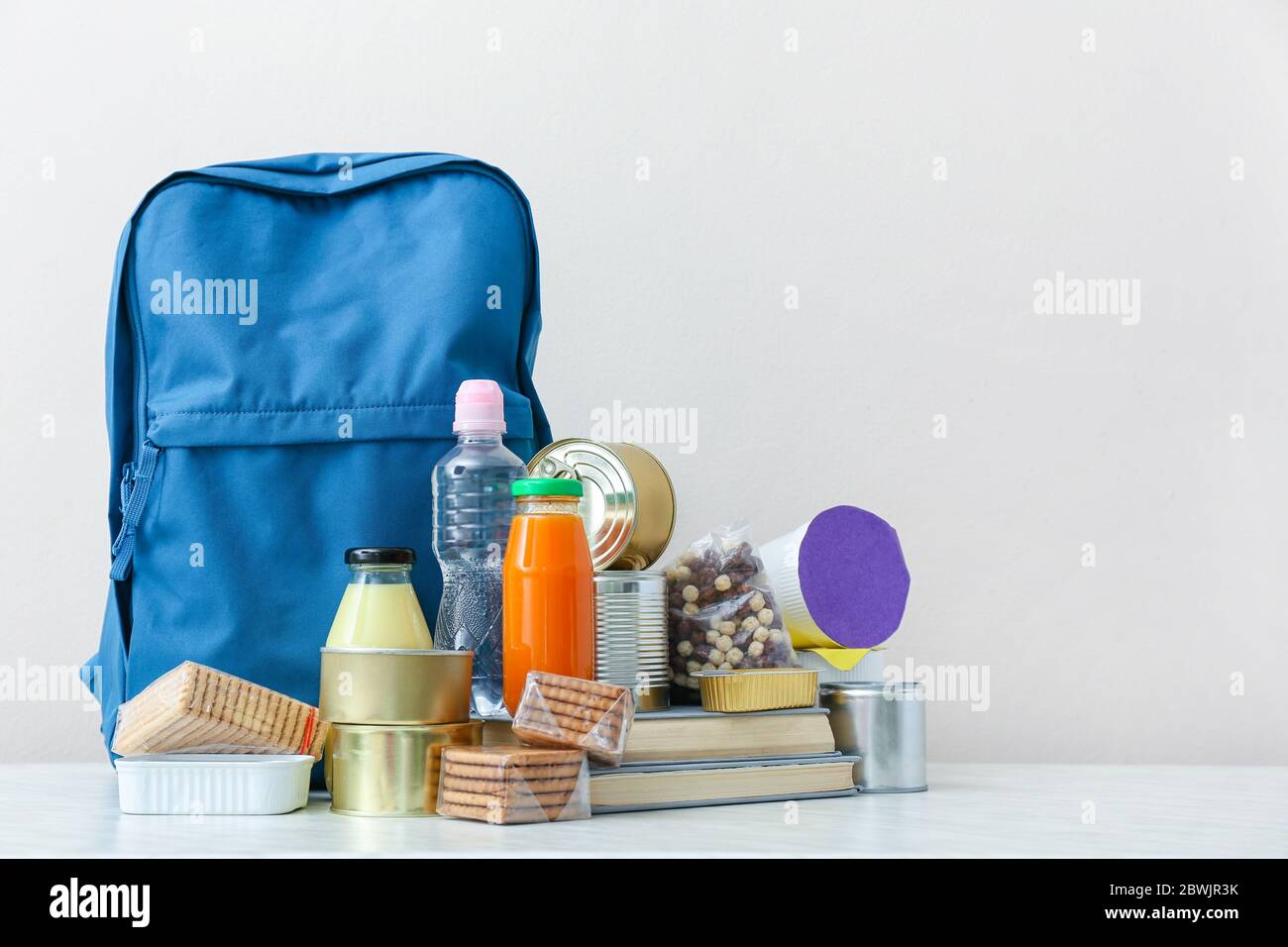 Schoolbag with different products on table. Concept of Backpack Food ...