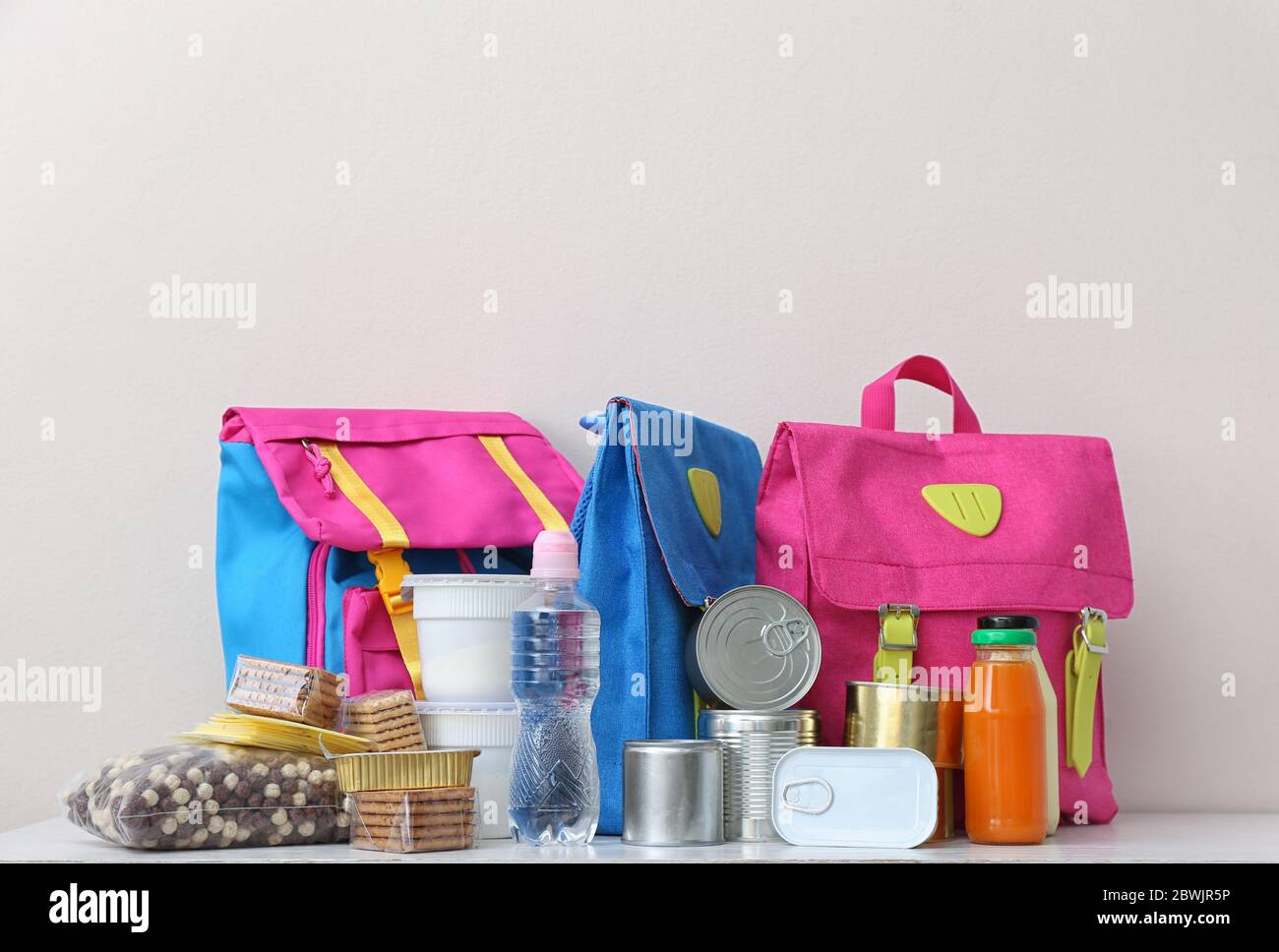 Schoolbag with different products on table. Concept of Backpack Food ...