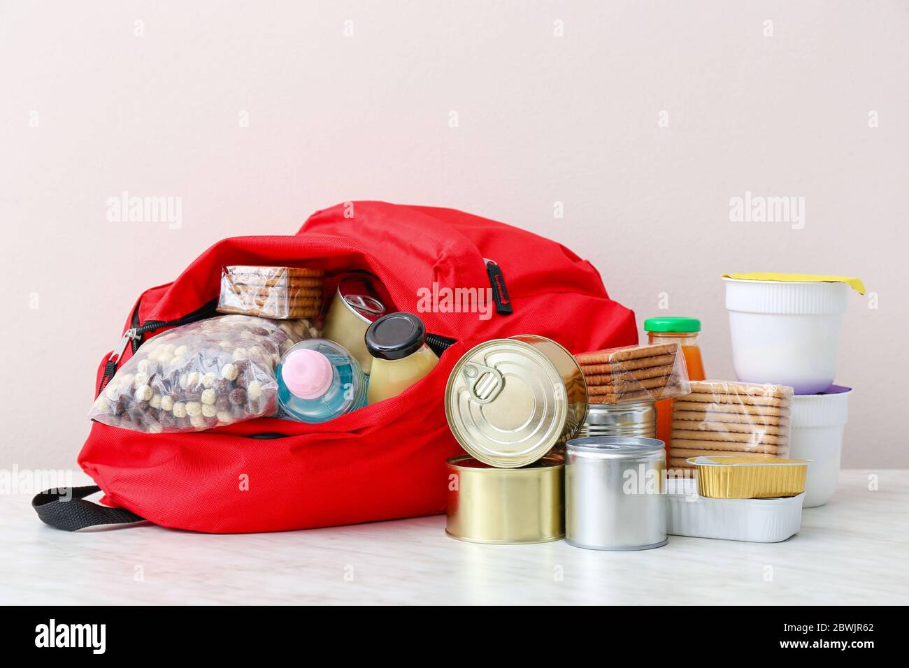 Schoolbag with different products on table. Concept of Backpack Food ...