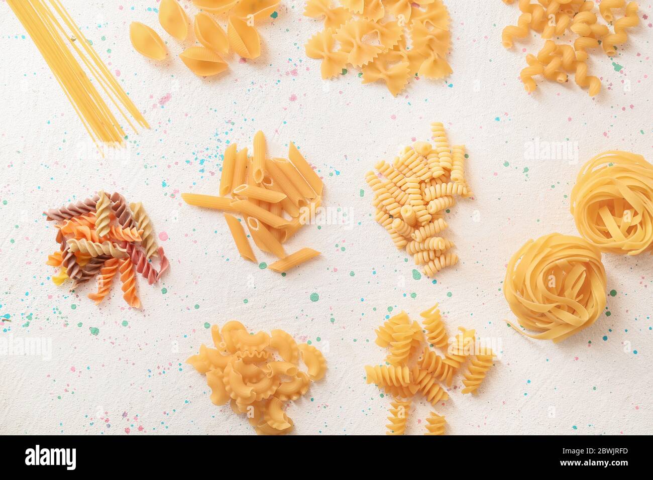 Different uncooked pasta on white background Stock Photo - Alamy