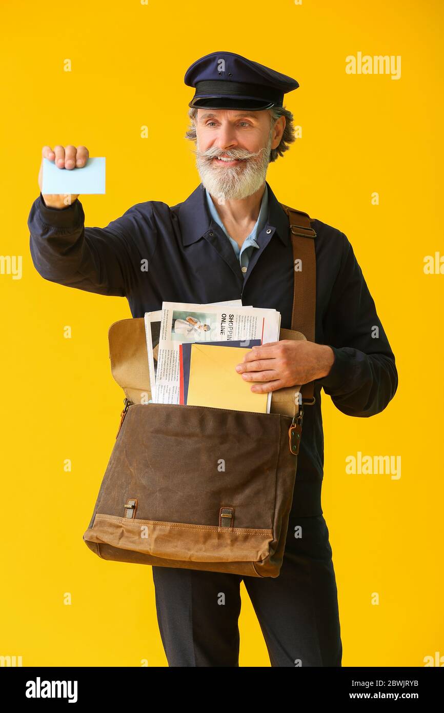 Handsome old postman on color background Stock Photo - Alamy