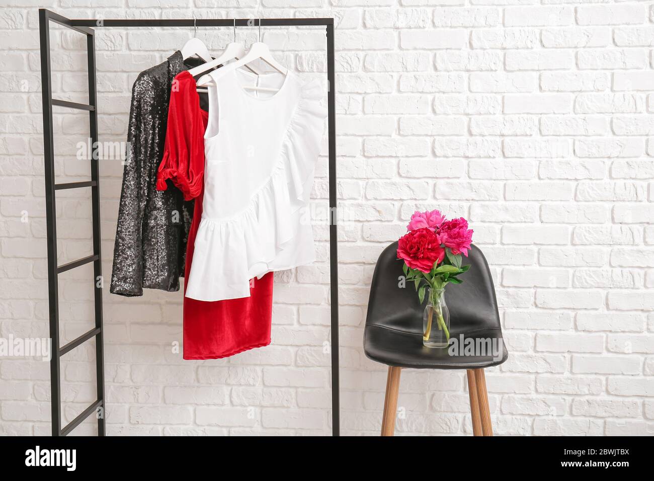 Vase with beautiful peony flowers on chair in dressing room Stock Photo ...