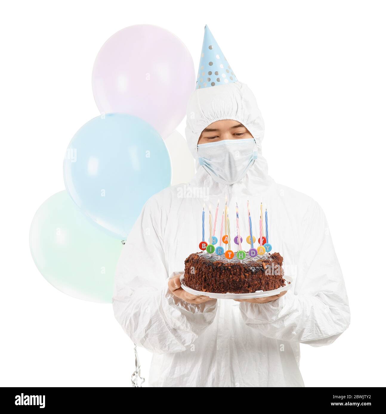 Asian man in biohazard suit and with Birthday cake on white background ...